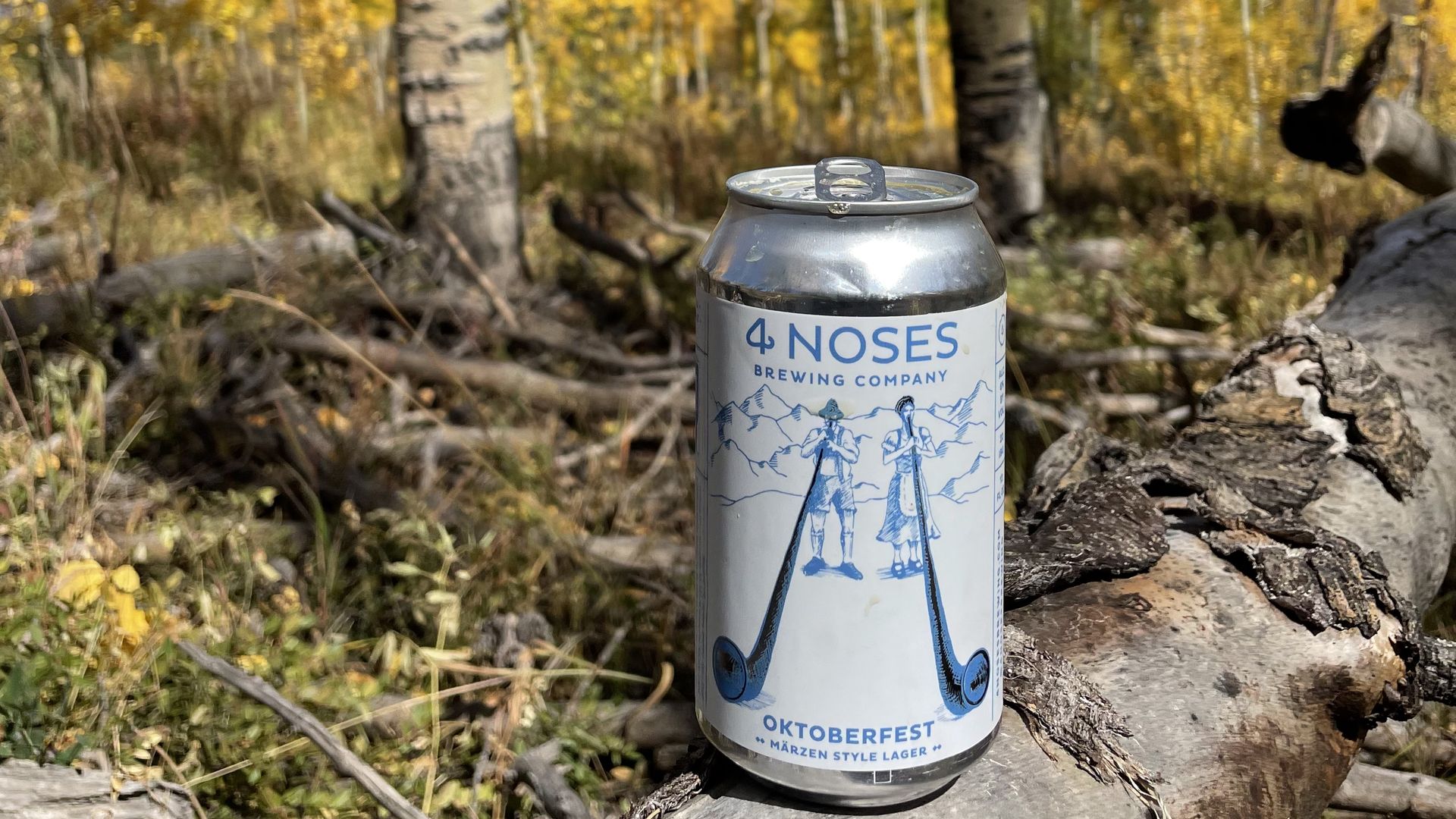 A can of 4 Noses Brewing Oktoberfest with fall colors in the background.