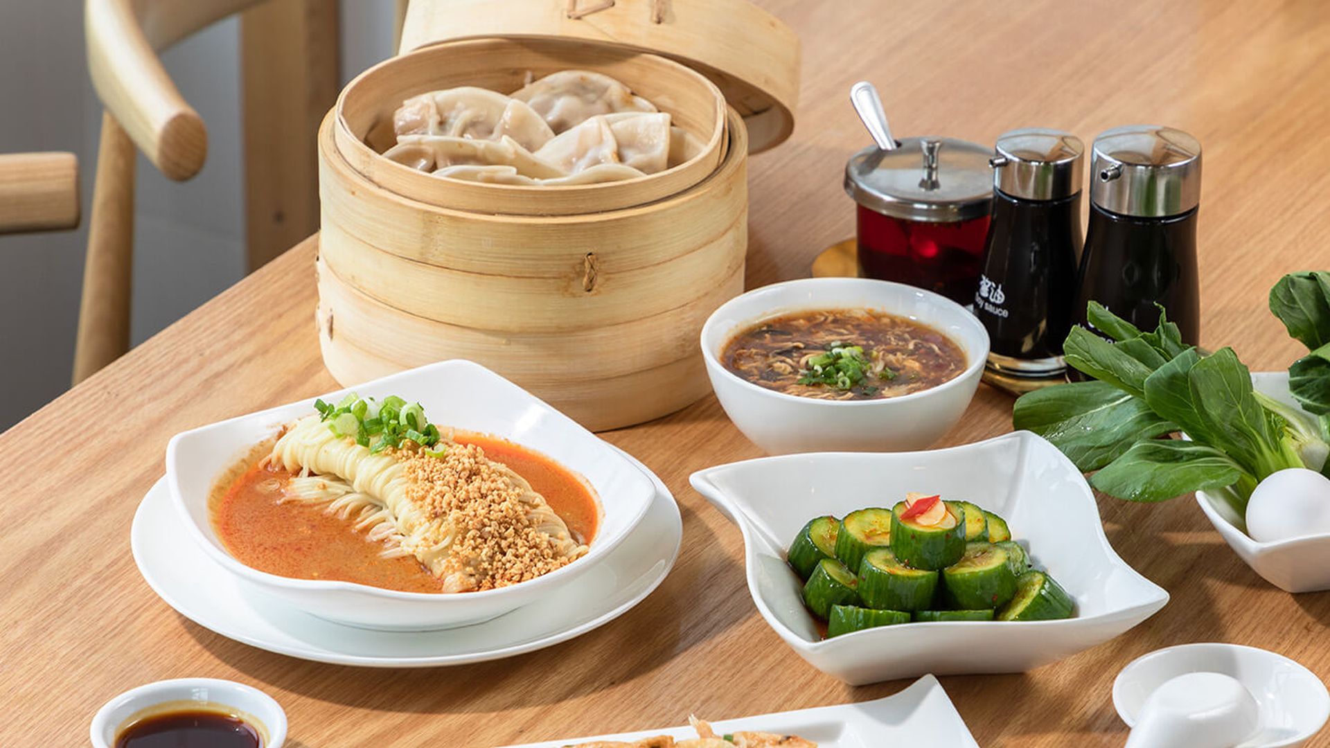 a bunch of dumplings and other Asian dishes on a table
