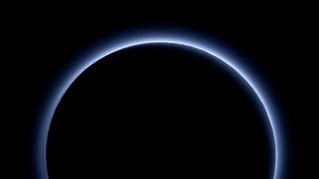 Pluto's hazy atmosphere keeps its surface icy cold
