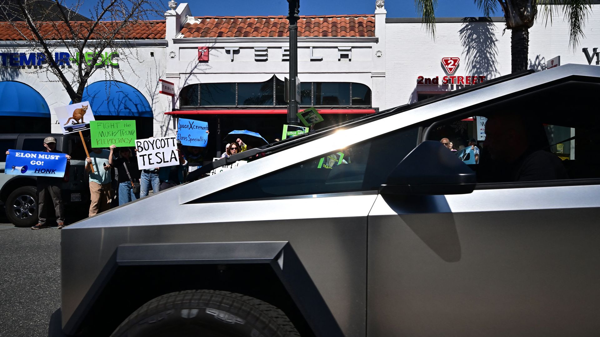 Three charged in arson attacks on Tesla properties