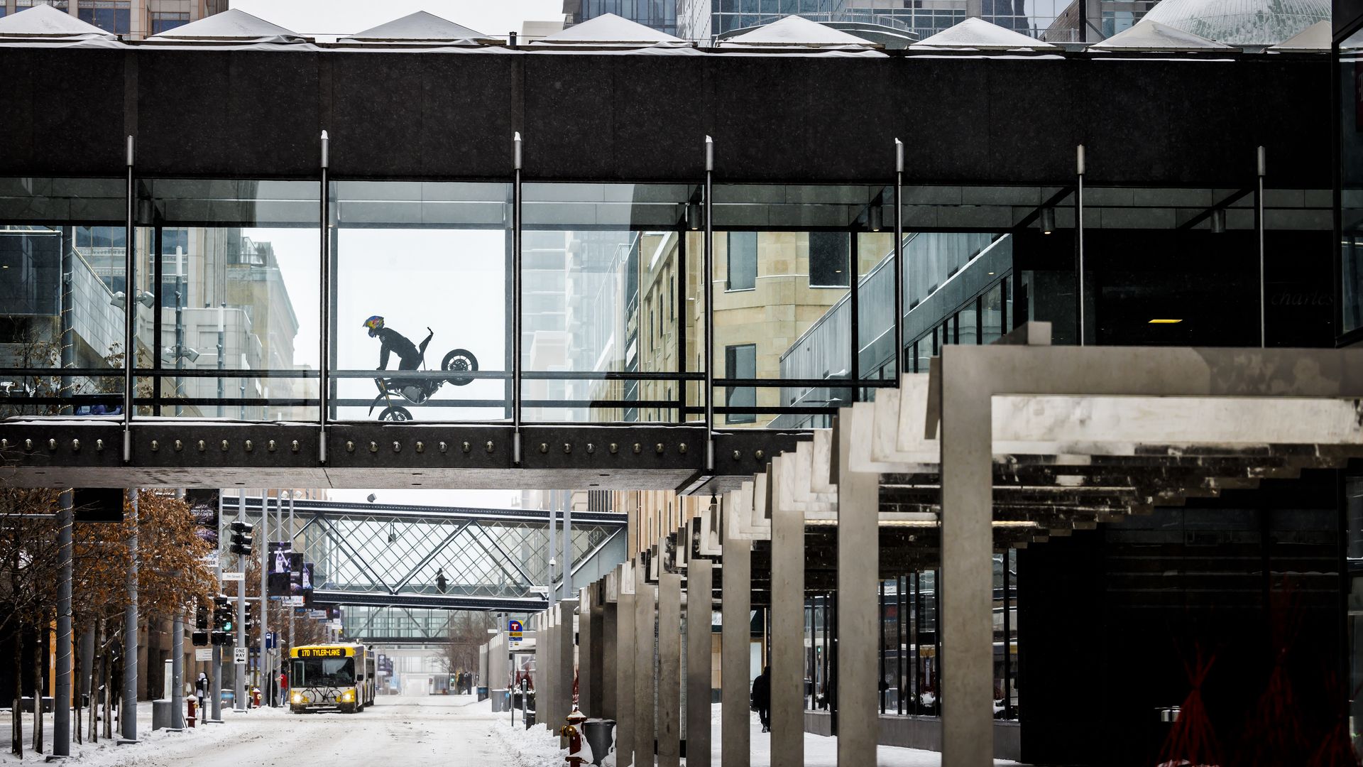 Professional stunt rider races motorcycle through downtown Minneapolis ...