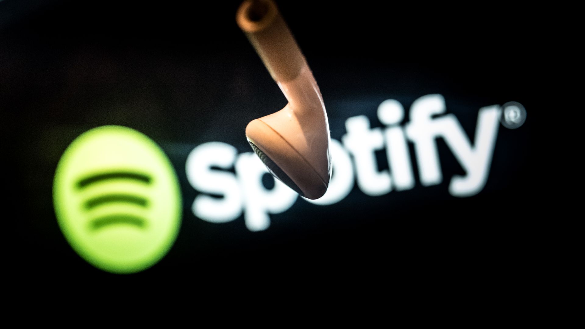 Spotify reports more paid users, continued losses